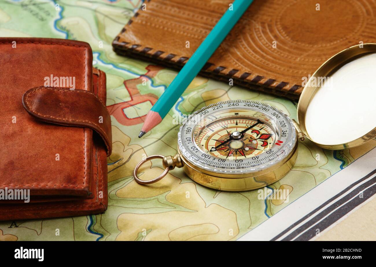 compass wallet and passport on the old map Stock Photo - Alamy