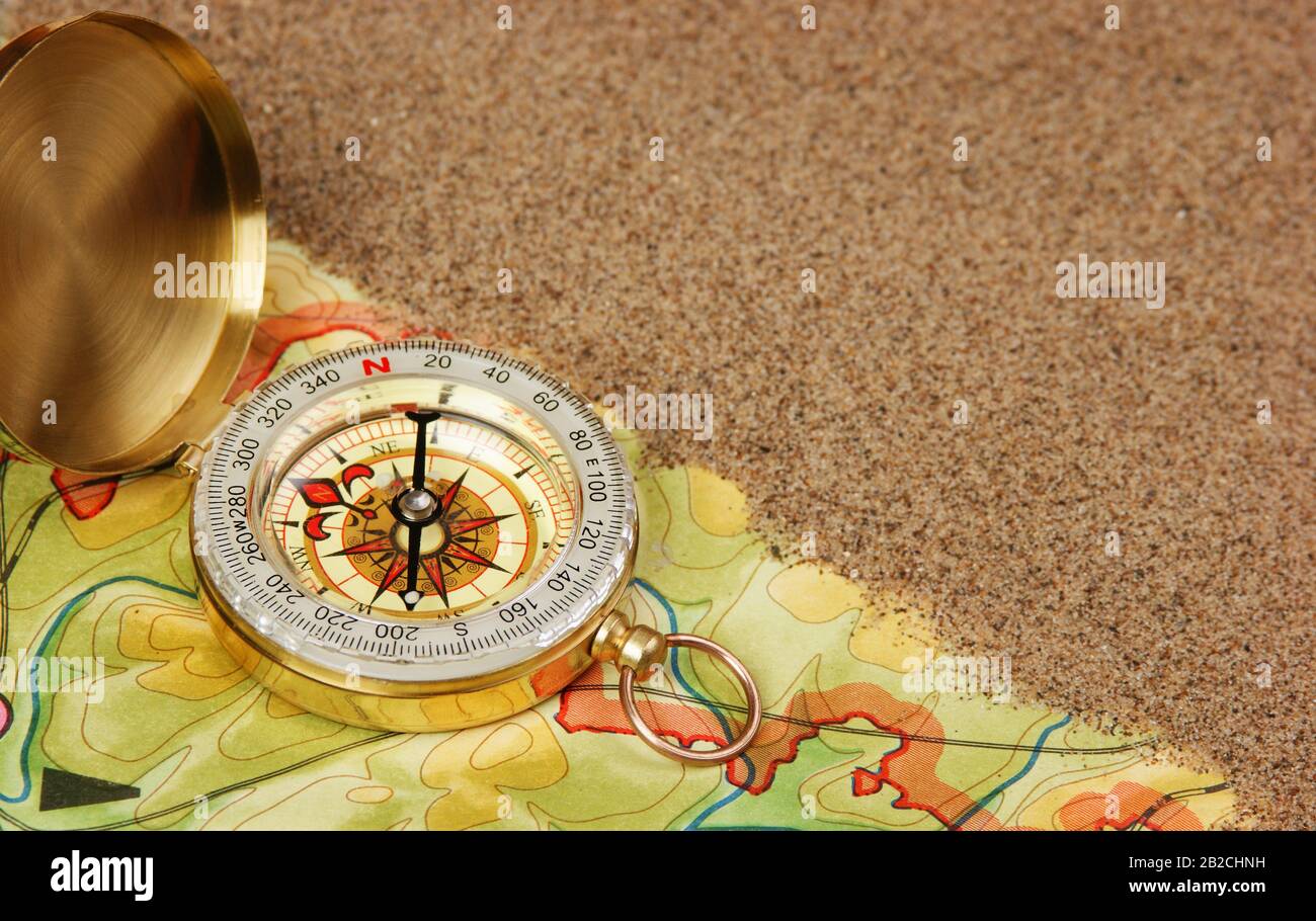 compass on the map with sand Stock Photo - Alamy