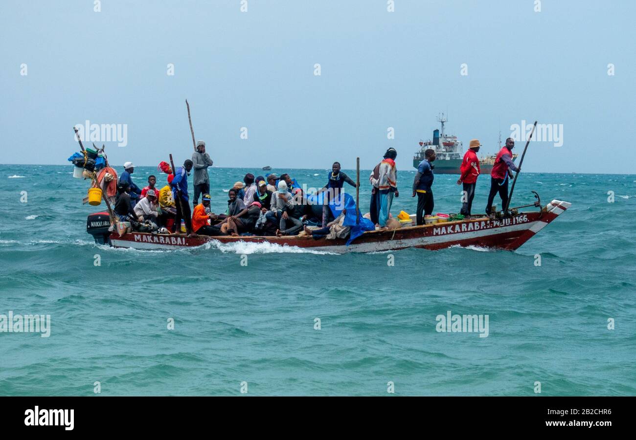 A heavy loaded, crowded, small boat in the sea near Stone town coast ...