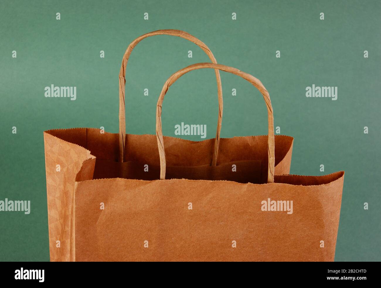 paper bag on a green background Stock Photo - Alamy