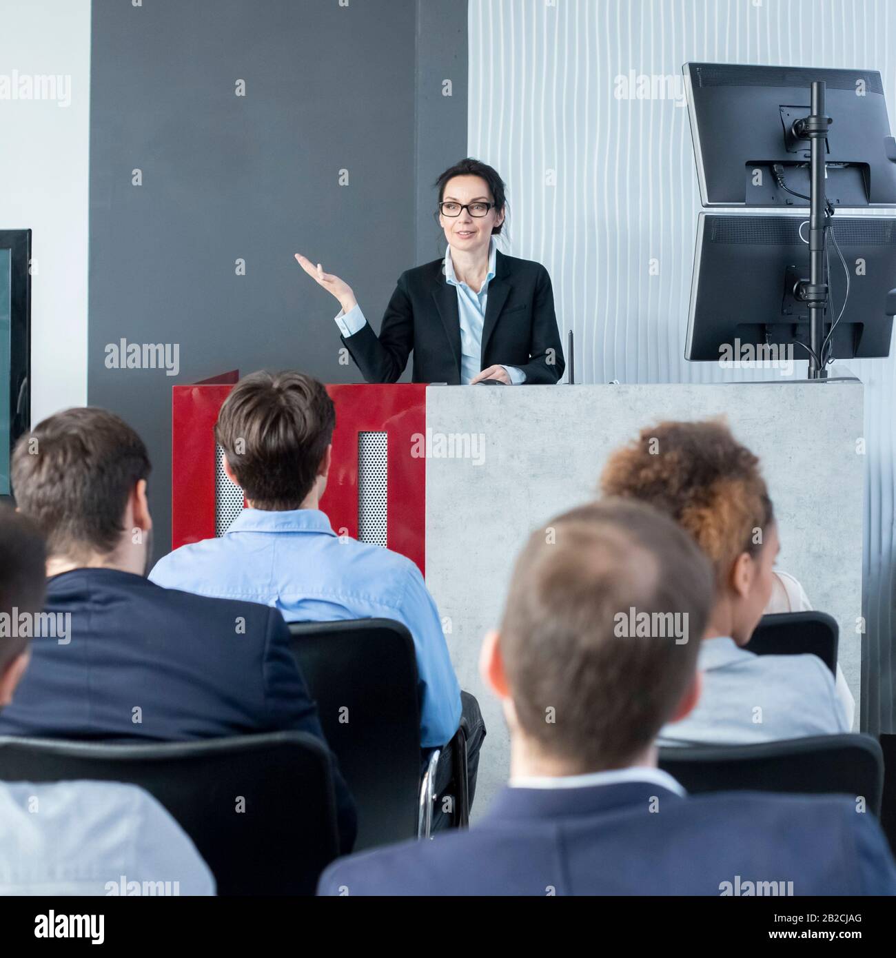 Confident CEO giving presentation to young staff Stock Photo - Alamy