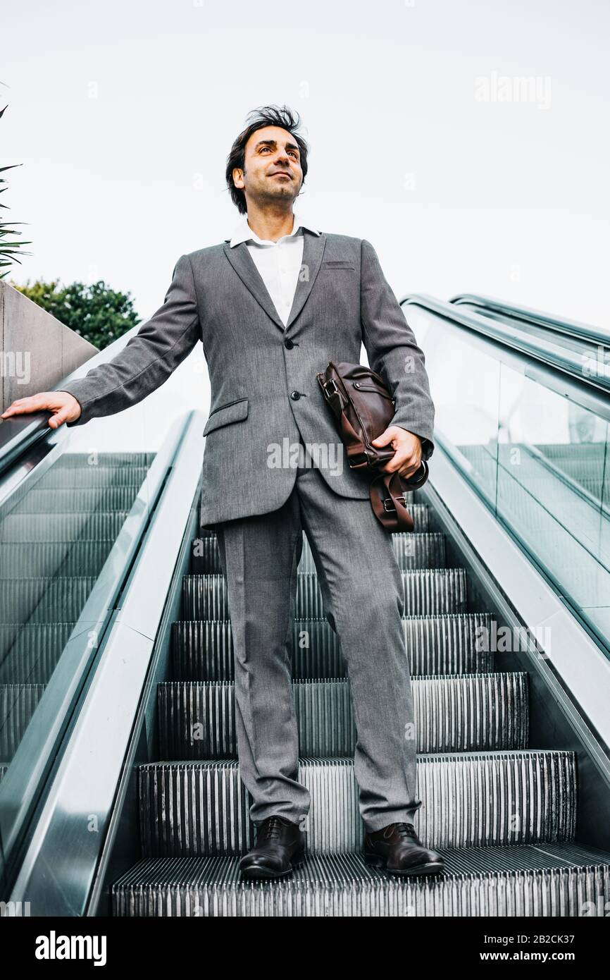 Airport escalator businessman smartphone hi-res stock photography and ...