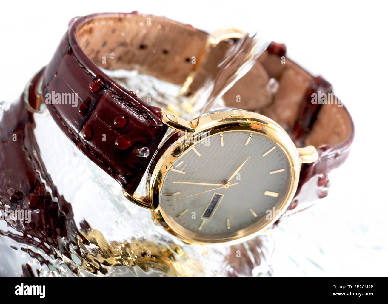 water flows over a luxury golden watch Stock Photo - Alamy