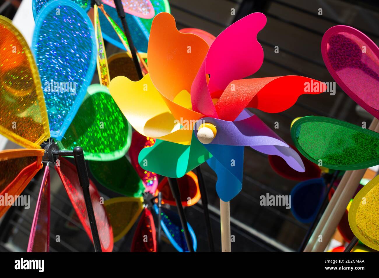 Rainbow colored pinwheels on sale in the view Stock Photo - Alamy