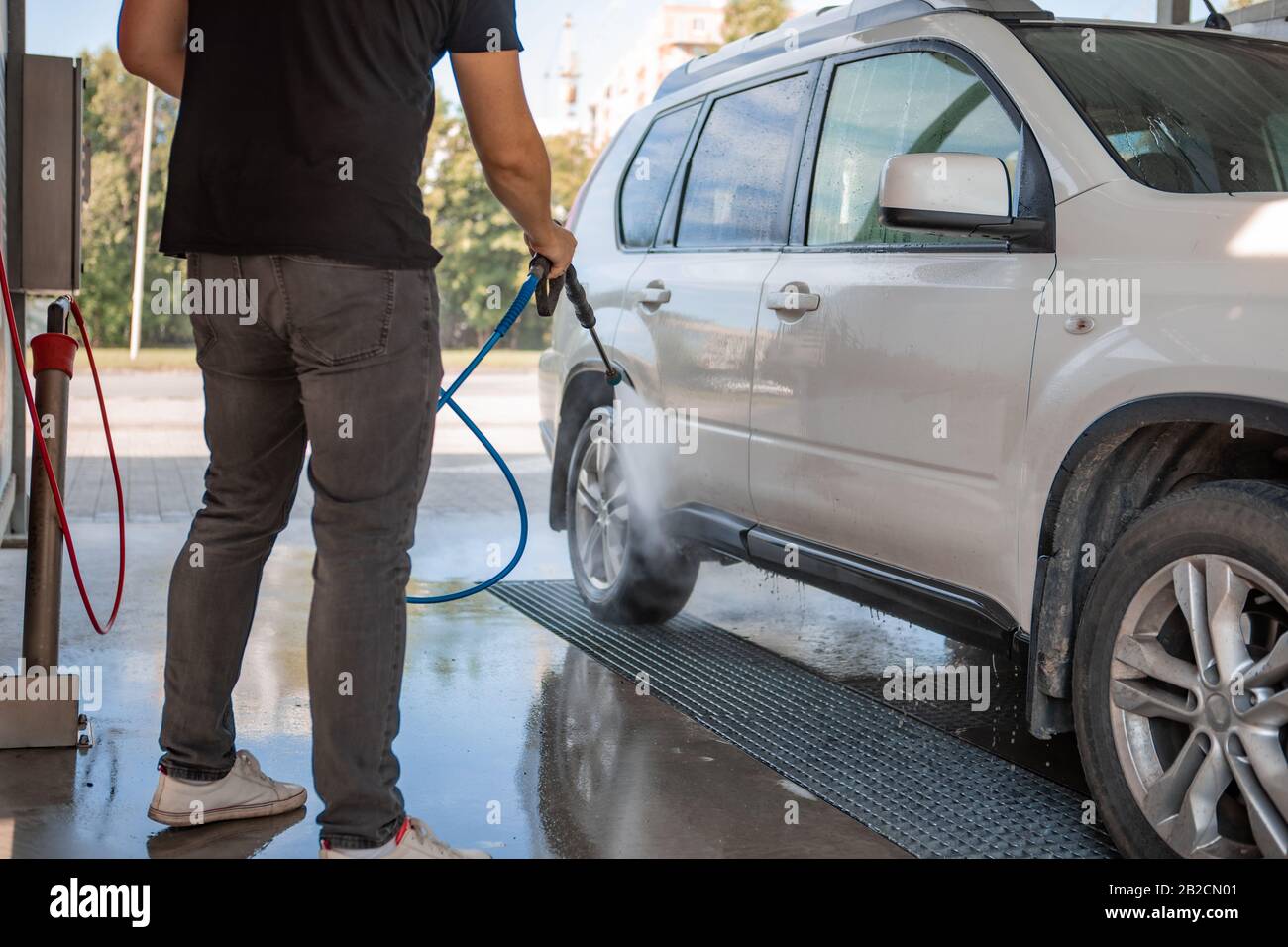 strong man washing car at self carwash outdoors Stock Photo - Alamy