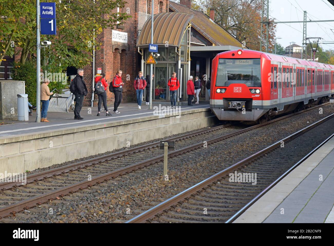 Passengers on platform catching a Deutsche Bahn train at Buxtehude ...