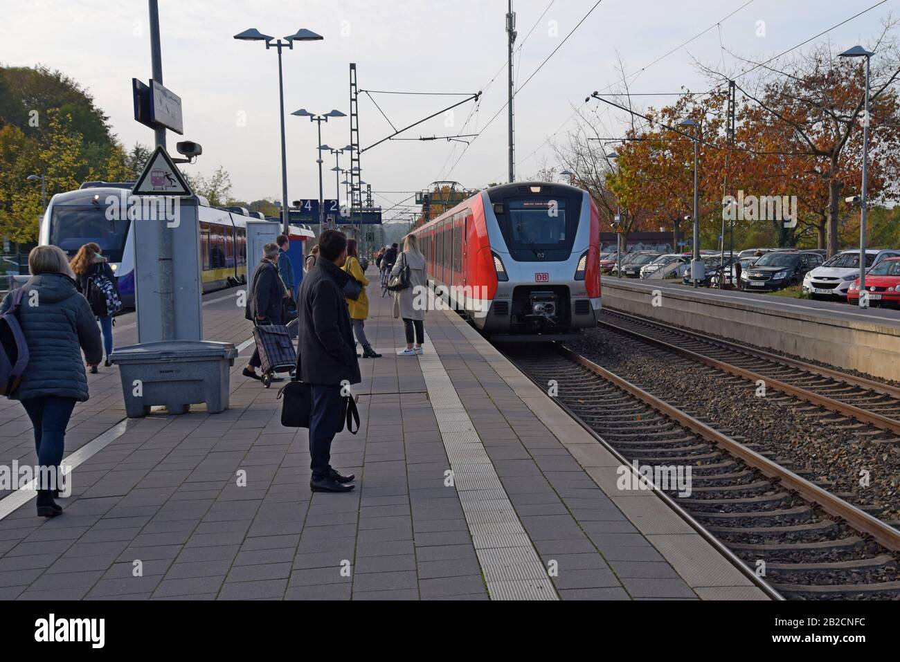Passengers on platform catching a Deutsche Bahn train at Buxtehude ...