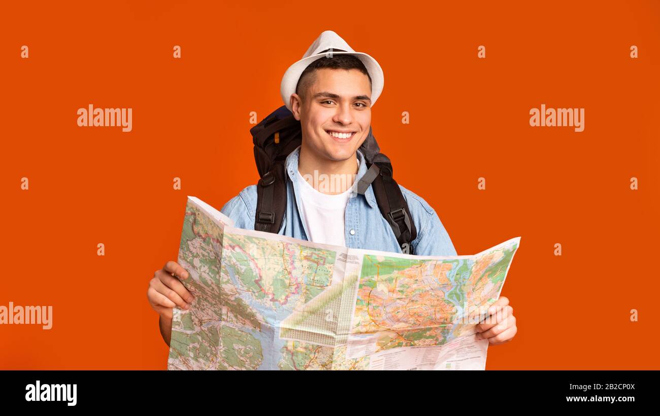 Joyful hiker with big backpack holding map Stock Photo - Alamy