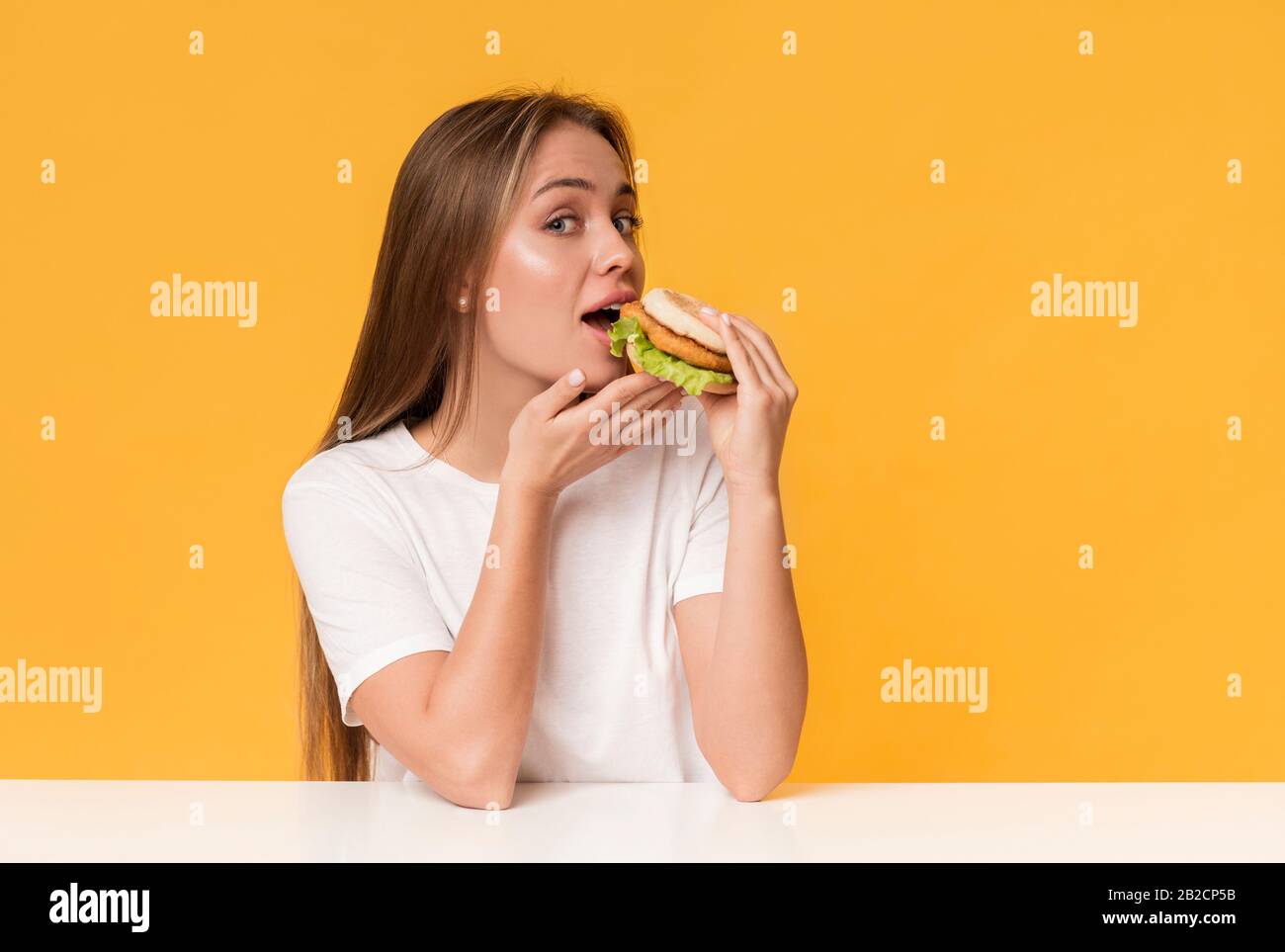 Cheat Meal. Hungry Woman Eating Fast Food, Biting Burger Stock Photo ...