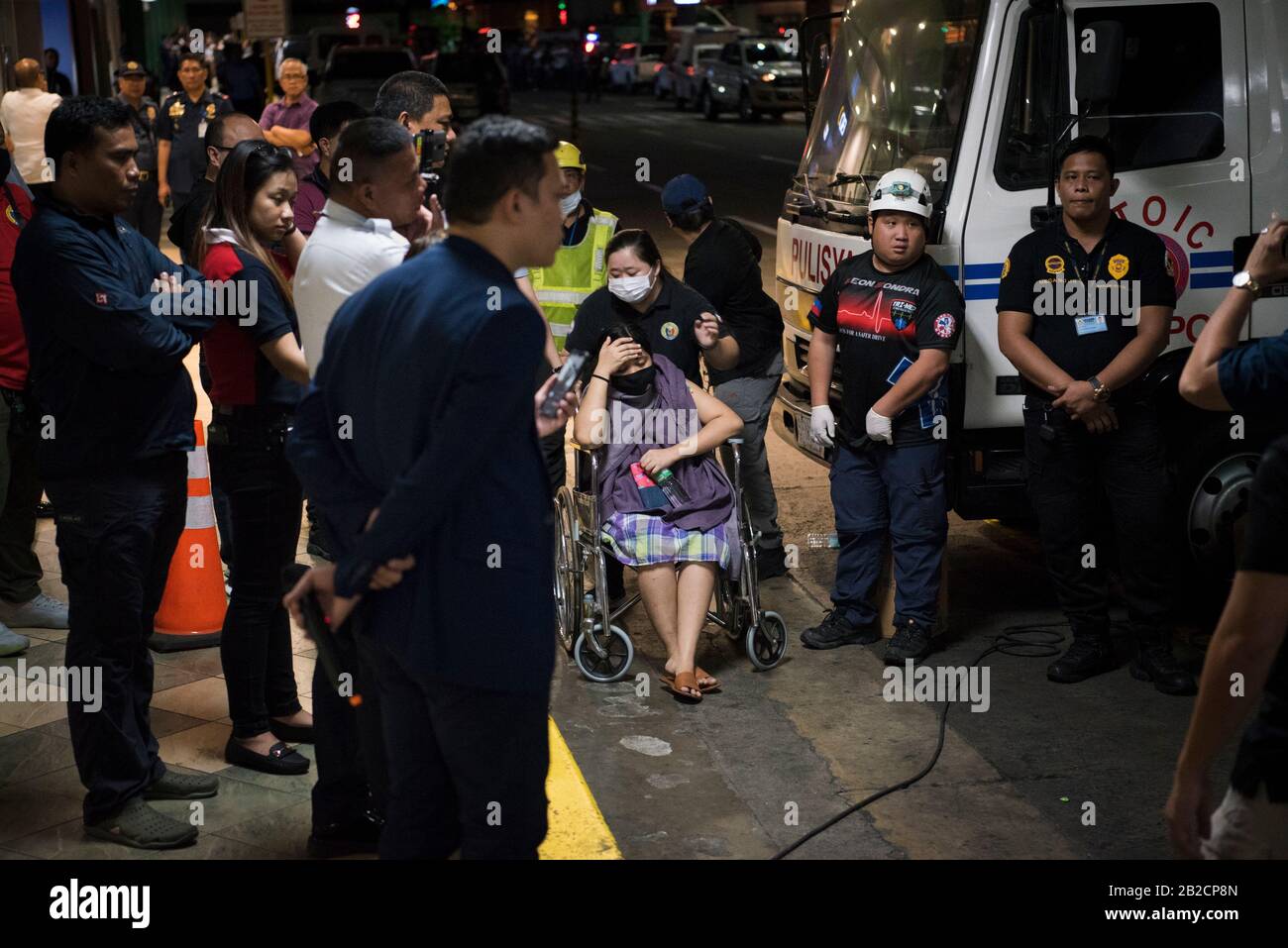 A freed hostage is seen in a wheelchair outside V shopping mall.Police ...