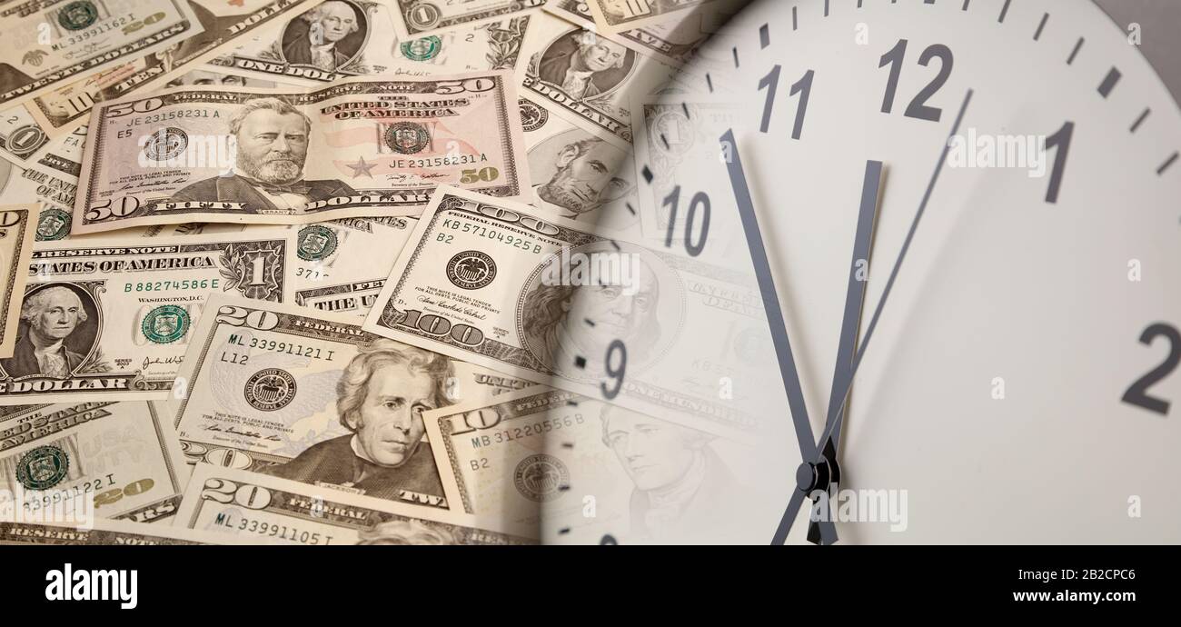 Clock and assorted American banknotes. Time is money idea Stock Photo ...