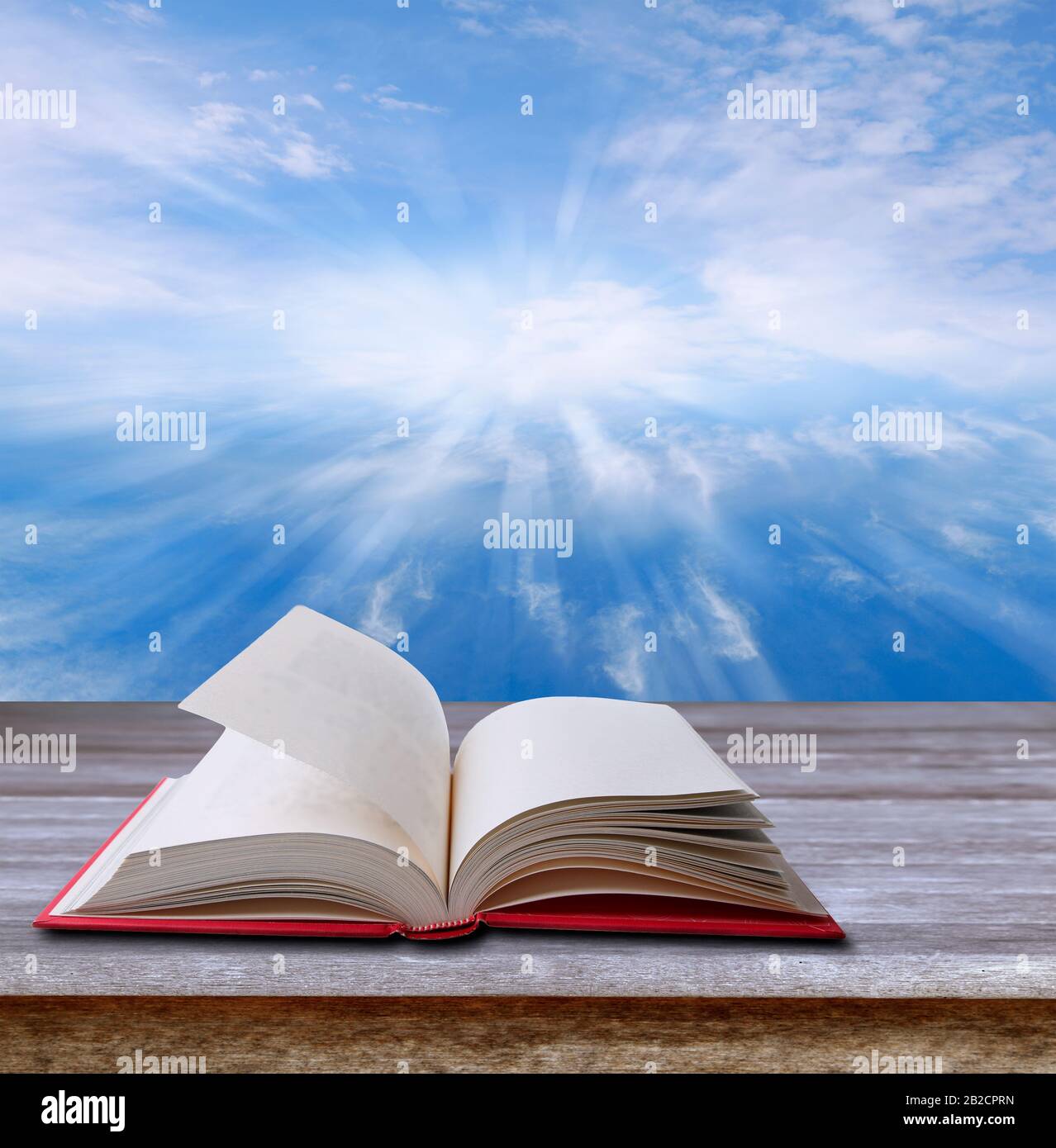 Open book on table and sky Stock Photo - Alamy