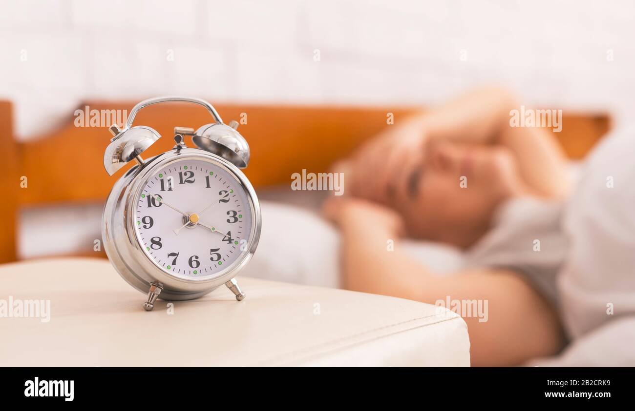 Senior woman lying in bed, woke up at 4 am Stock Photo - Alamy