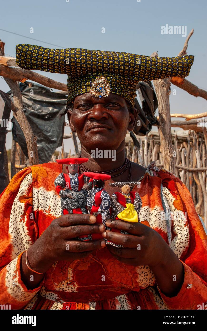 Herero woman in traditional clothes at the C35 road near Khorixas ...