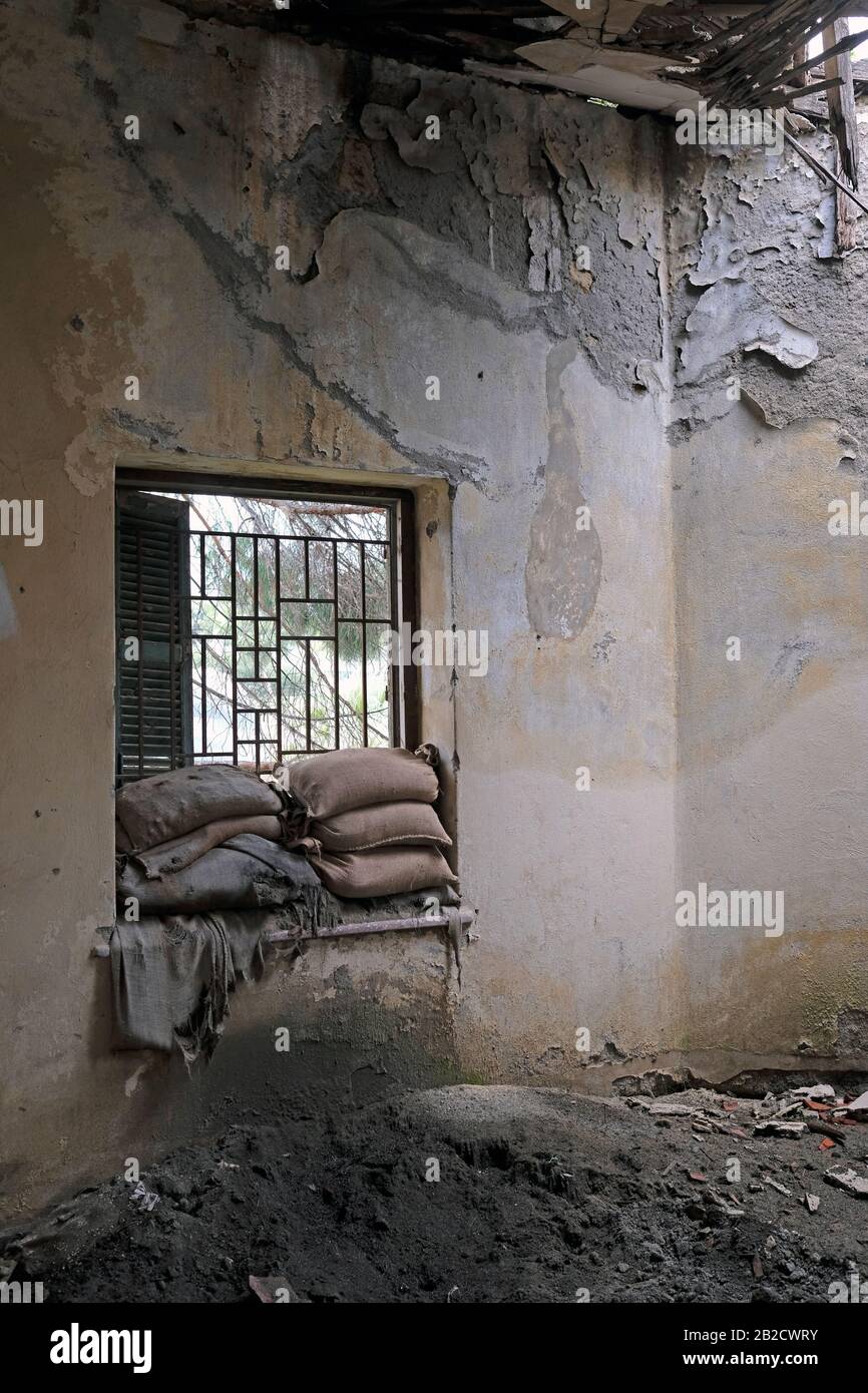 Sandbags piled up at a window of a house in the buffer zone "Green Line ...