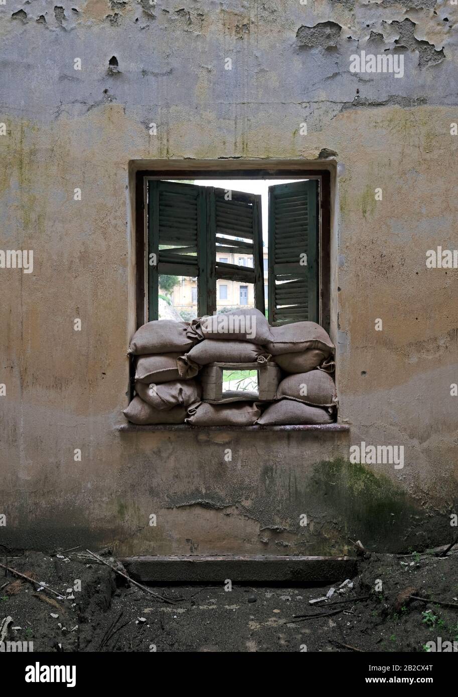 Sandbags piled up at a window of a house in the buffer zone "Green Line ...