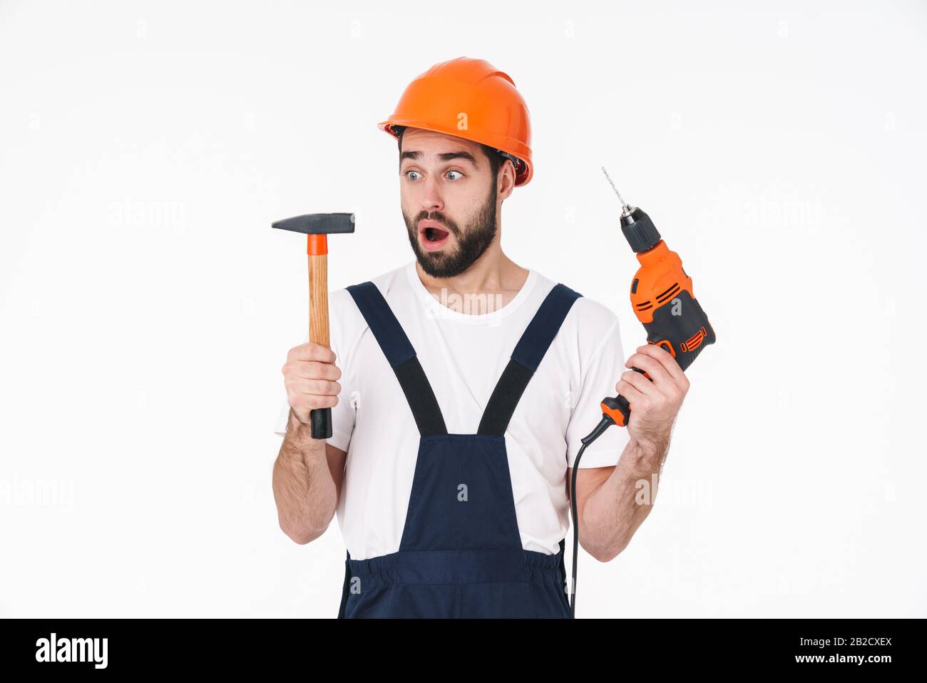 Image of shocked surprised young man builder in helmet posing isolated ...