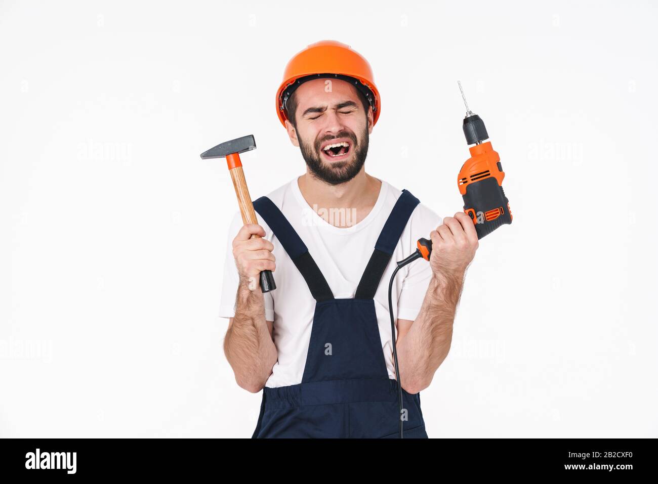 Image of sad young man builder in helmet cry isolated over white wall ...