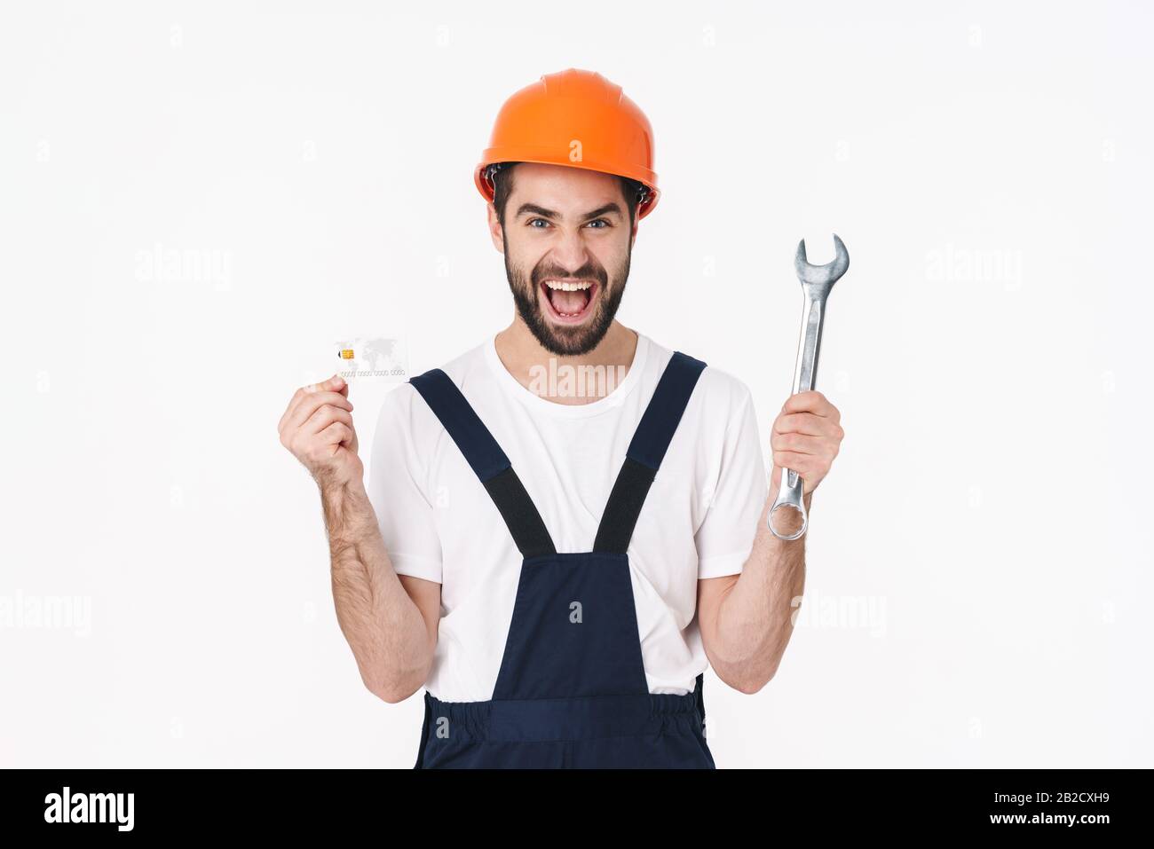 Image of emotional happy young man builder in helmet isolated over ...