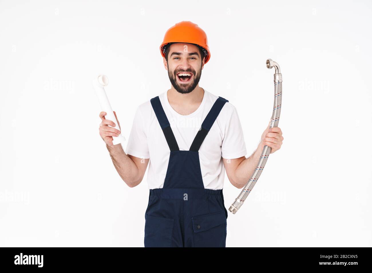 Picture of happy young man builder in helmet isolated over white wall ...
