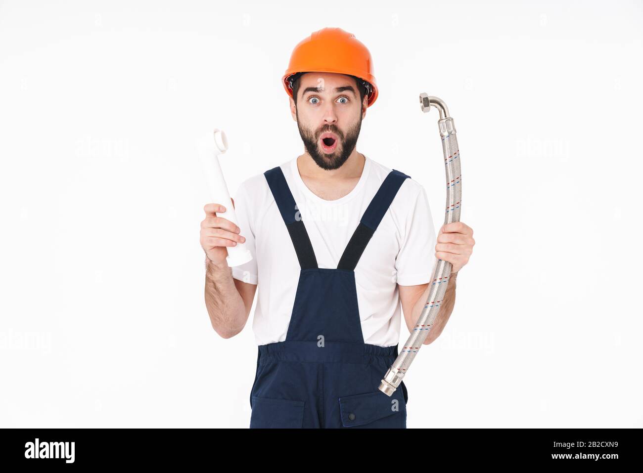 Image of shocked young man builder in helmet isolated over white wall ...