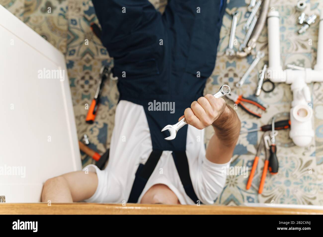 Image of a handsome young man plumber work in uniform indoors Stock ...