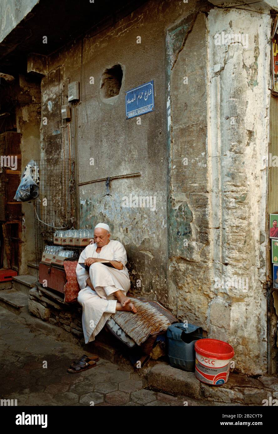 Travel Photography - Egyptian man reading in the alleyways of Islamic ...