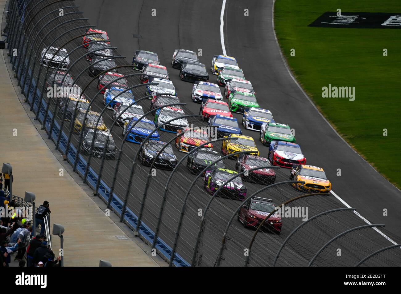 NASCAR Cup Series drivers line their cars up five wide in a salute to ...