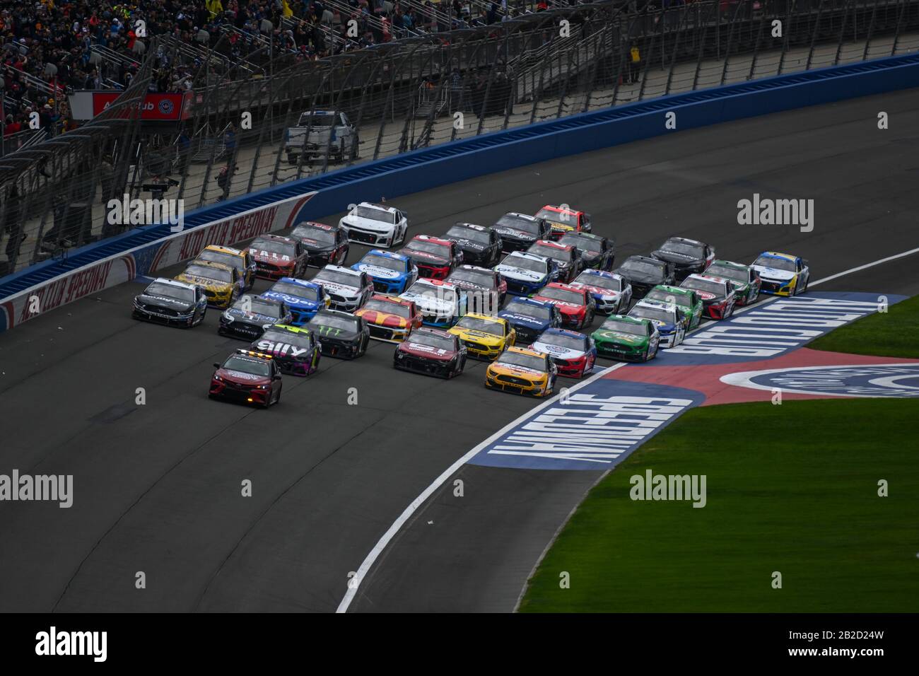 NASCAR Cup Series drivers line their cars up five wide in a salute to ...