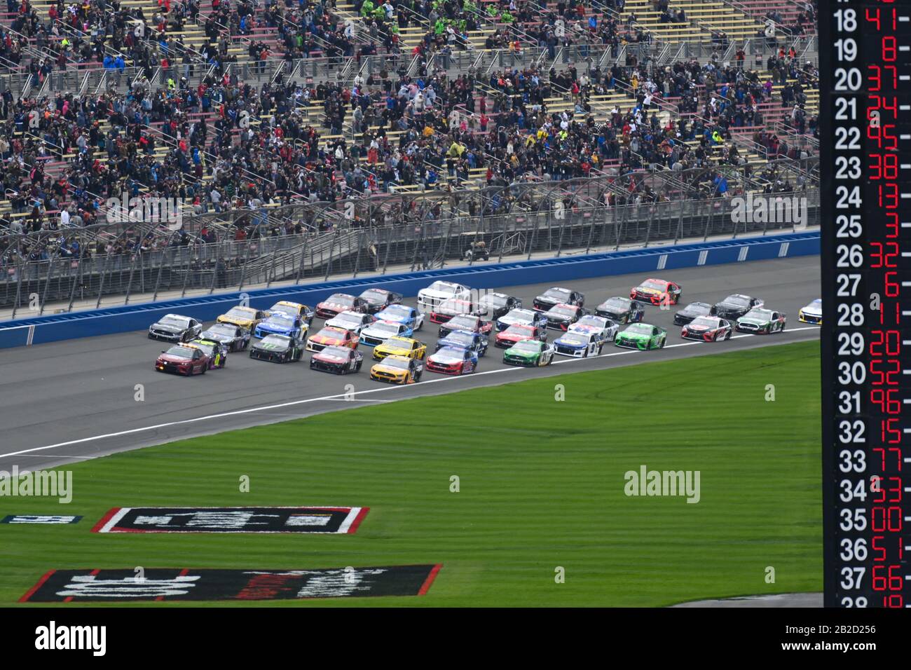 NASCAR Cup Series drivers line their cars up five wide in a salute to ...