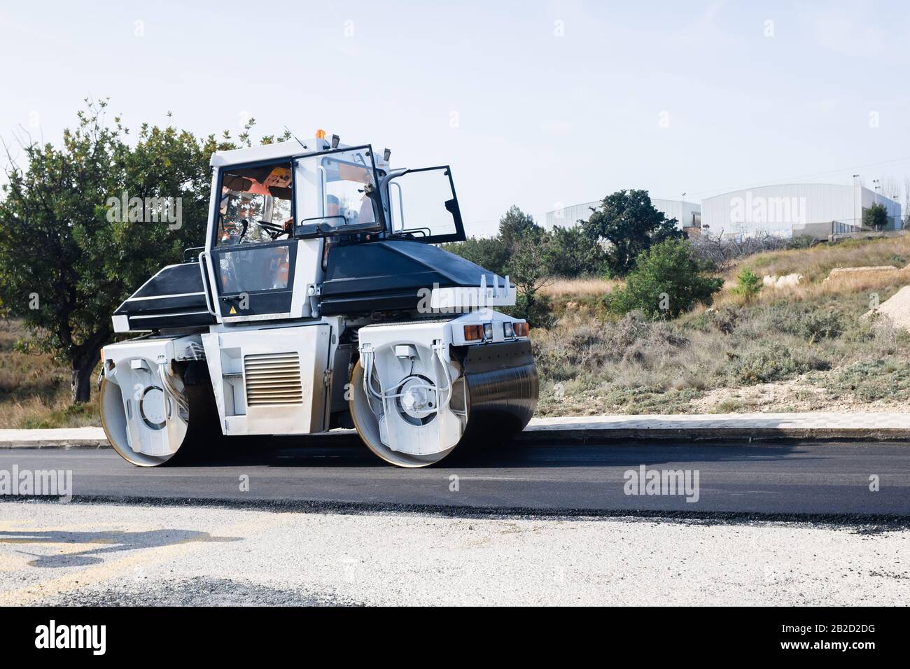 Asphalt roller compactor machine working on the paving of a road Stock ...