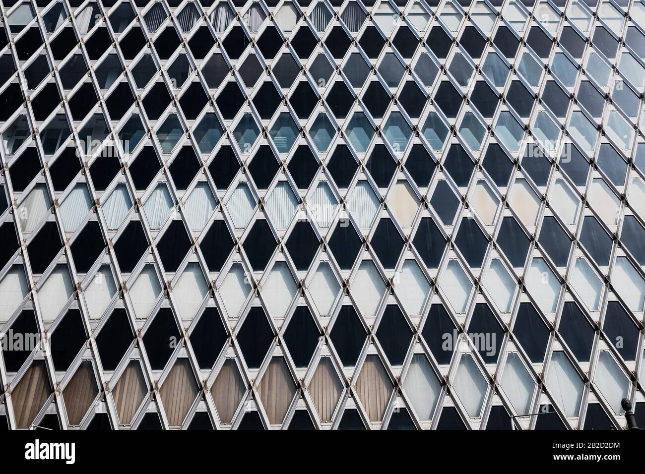 Geometric rhombus pattern on the metal facade of a building in the sun ...