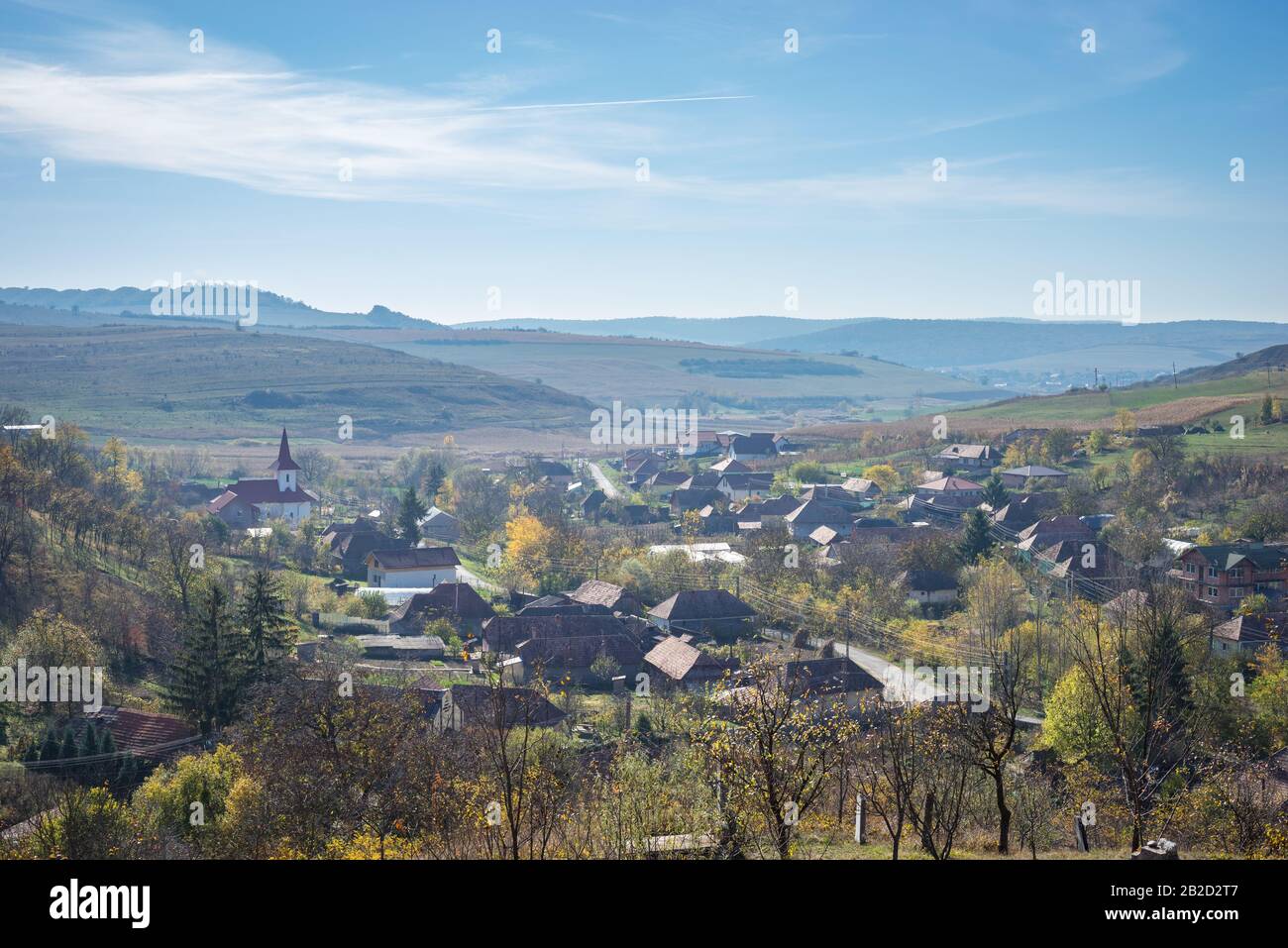 View of a typical village in central Romania on a hazy autumn afternoon ...