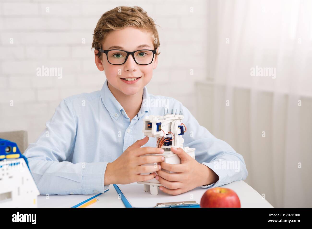 Innovation concept. Smart boy showing robot at lesson Stock Photo - Alamy