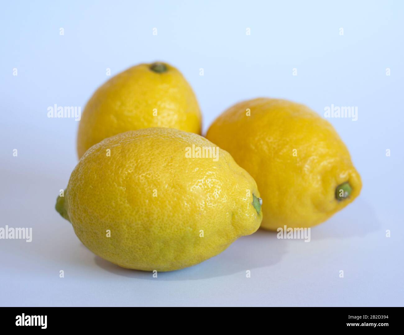 Three fresh whole lemons Stock Photo - Alamy