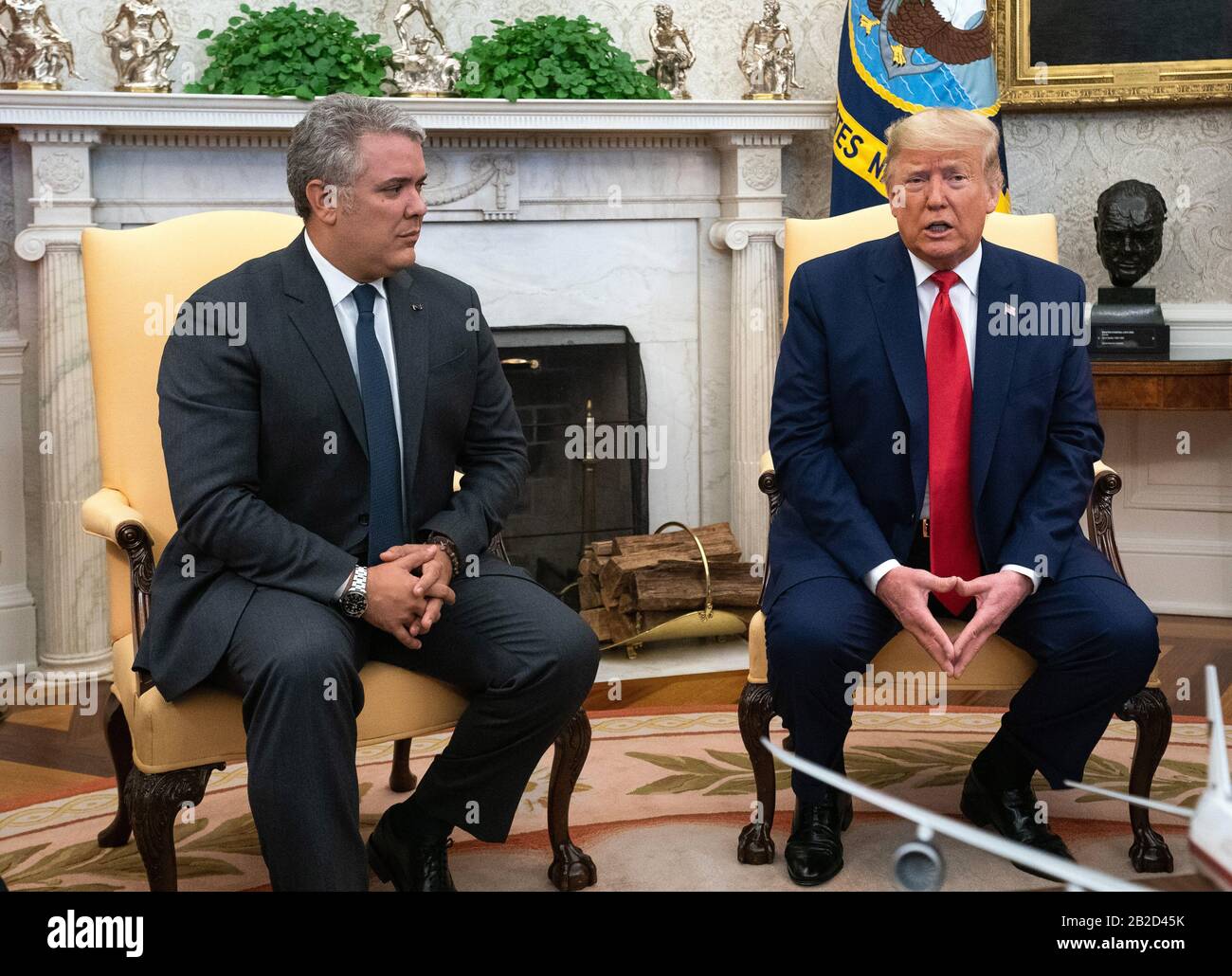 President Donald Trump (R) speaks to the media as he meets with ...