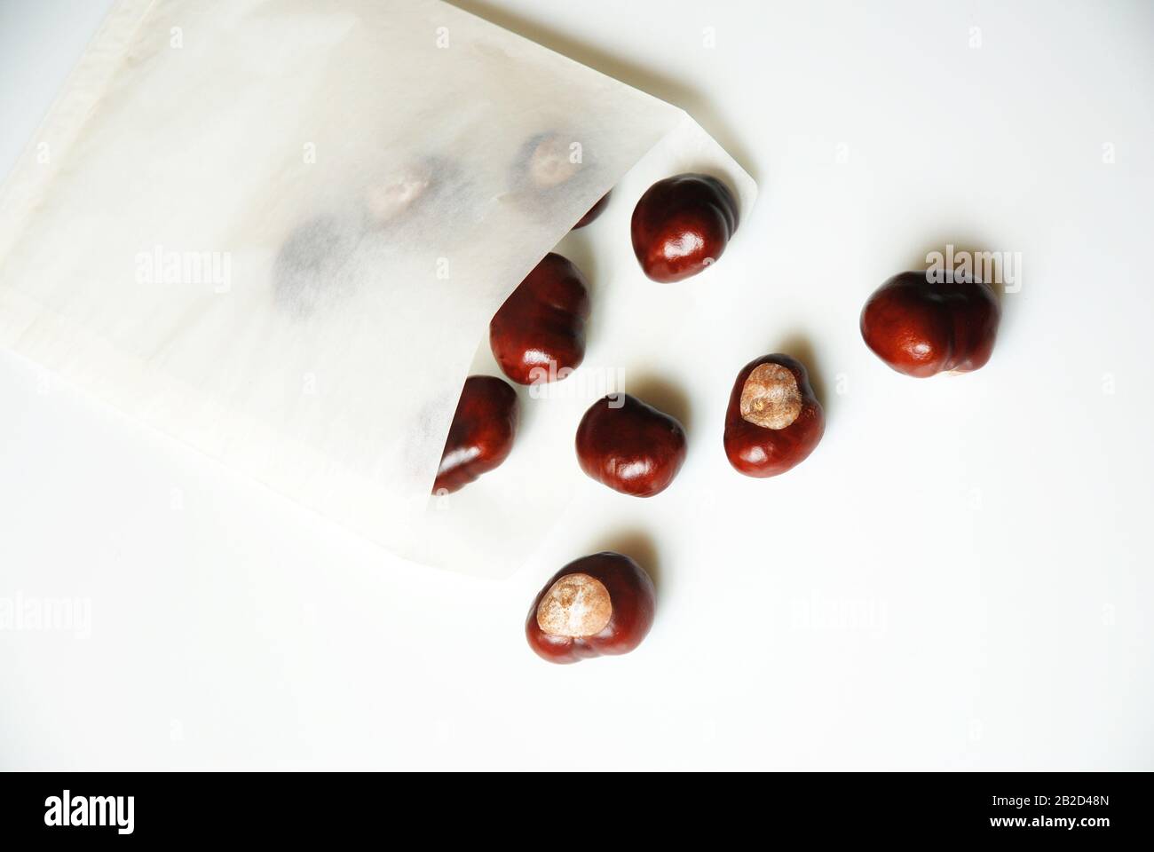 white paper bag with chestnuts isolated Stock Photo - Alamy