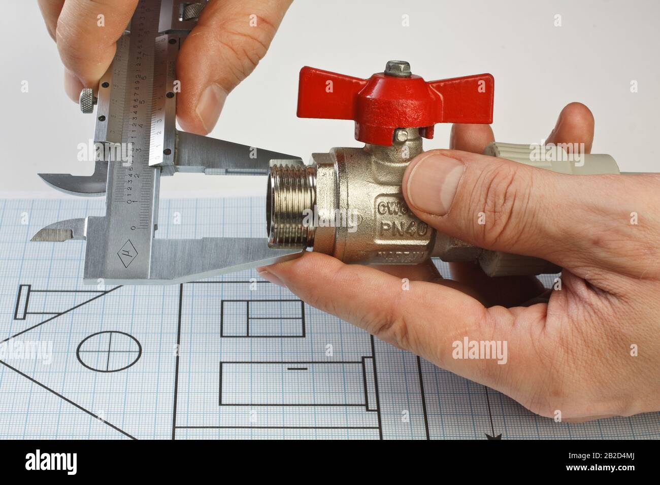 plumbing fittings in hand on the drawing Stock Photo - Alamy
