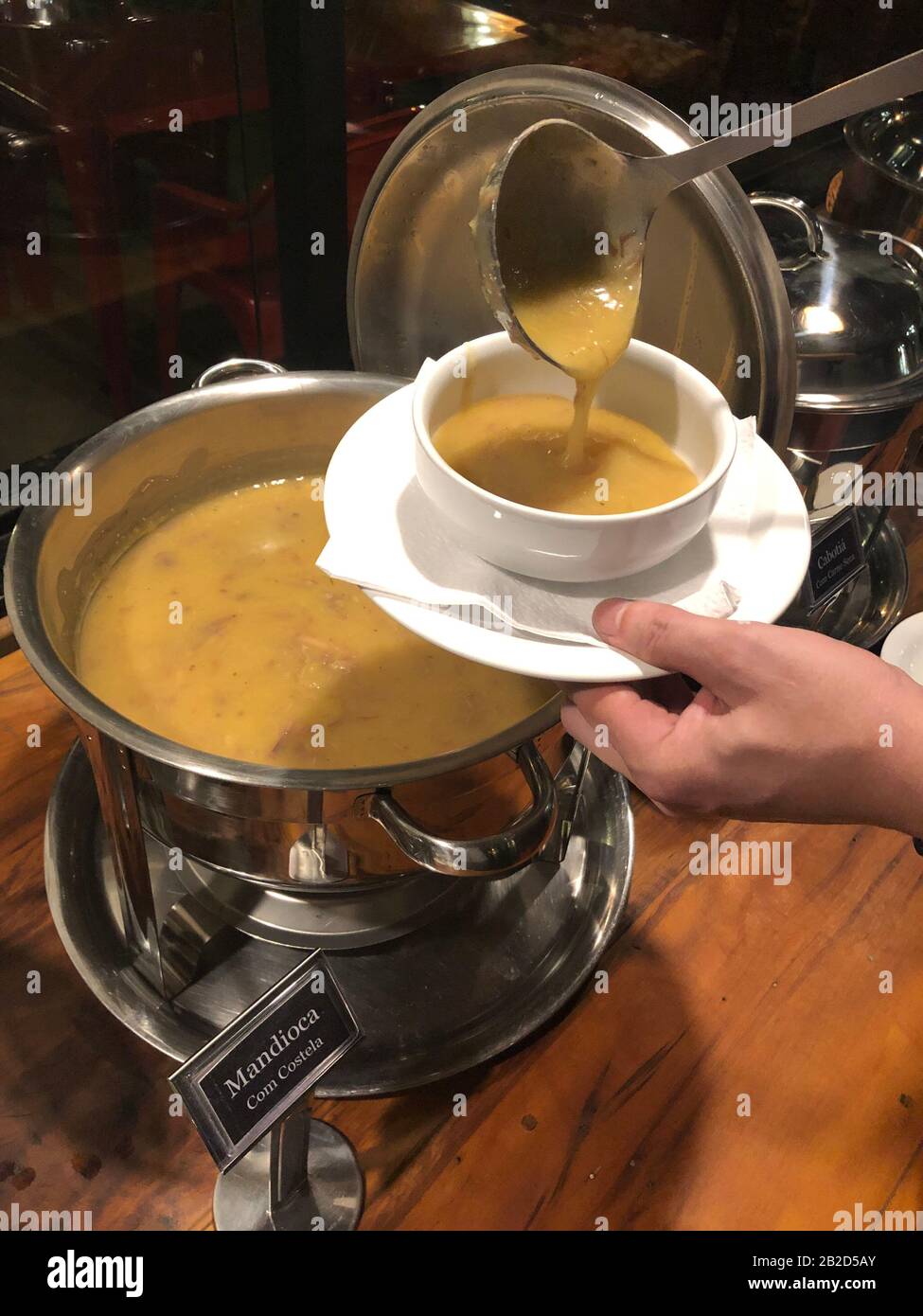 Photo of soup being served inside a restaurant. Color image, inside ...