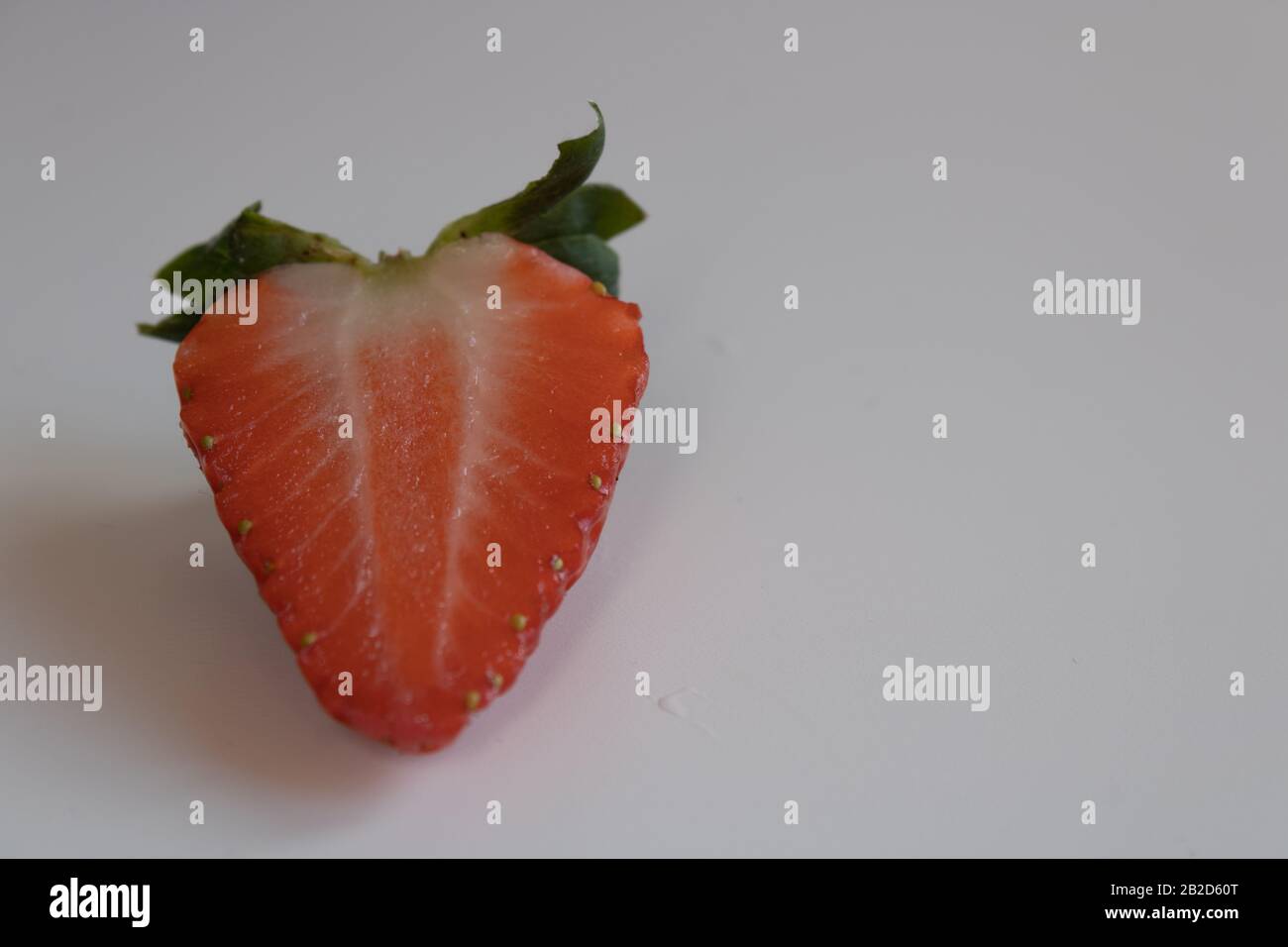 strawberry cut in half isolated on white background Stock Photo - Alamy