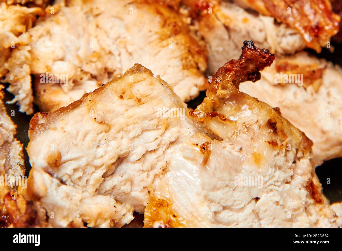 baked meat cut into pieces close up photo Stock Photo - Alamy