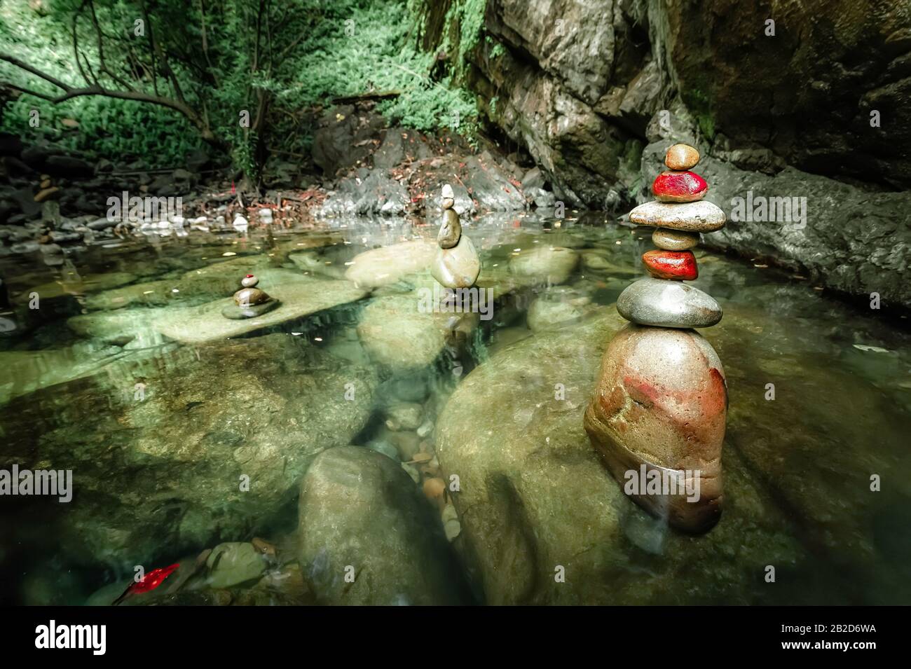 Amazing tropical rain forest landscape with lake and balancing rocks ...