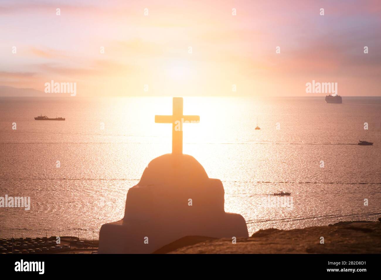 Amazing sunset colors of Aegean sea. Orthodox church cross ...