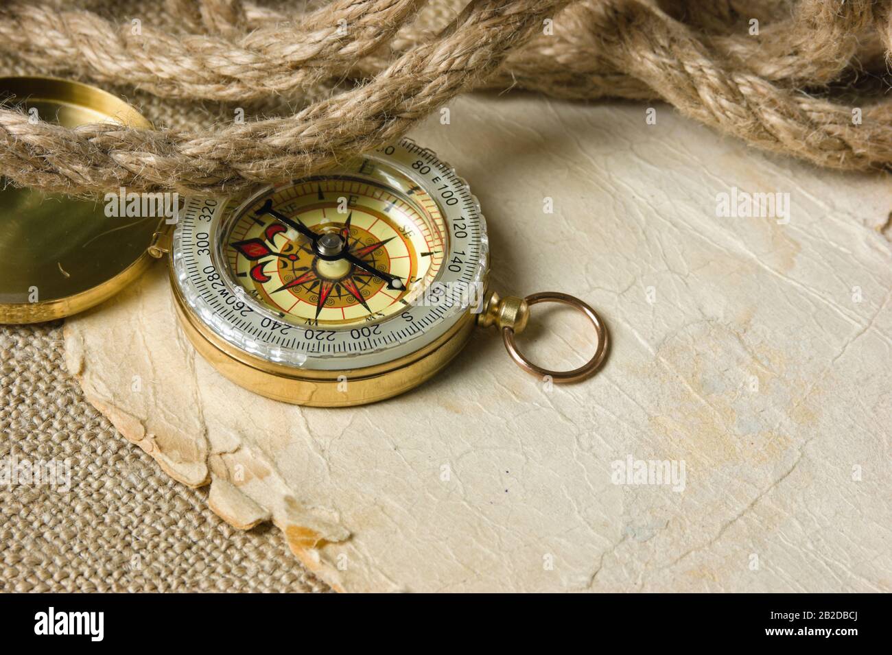 Vintage background with old paper and compass Stock Photo - Alamy