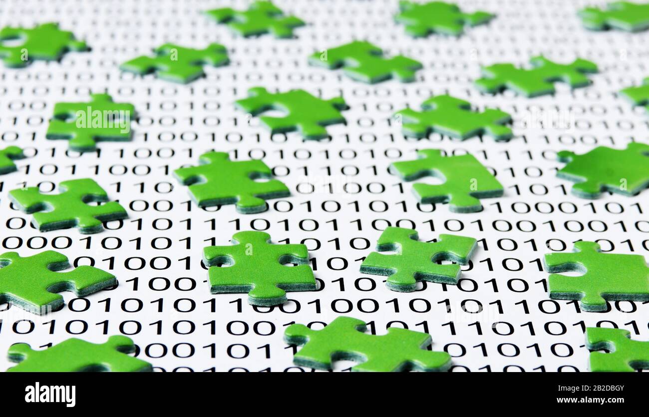 green puzzles and binary code Stock Photo - Alamy