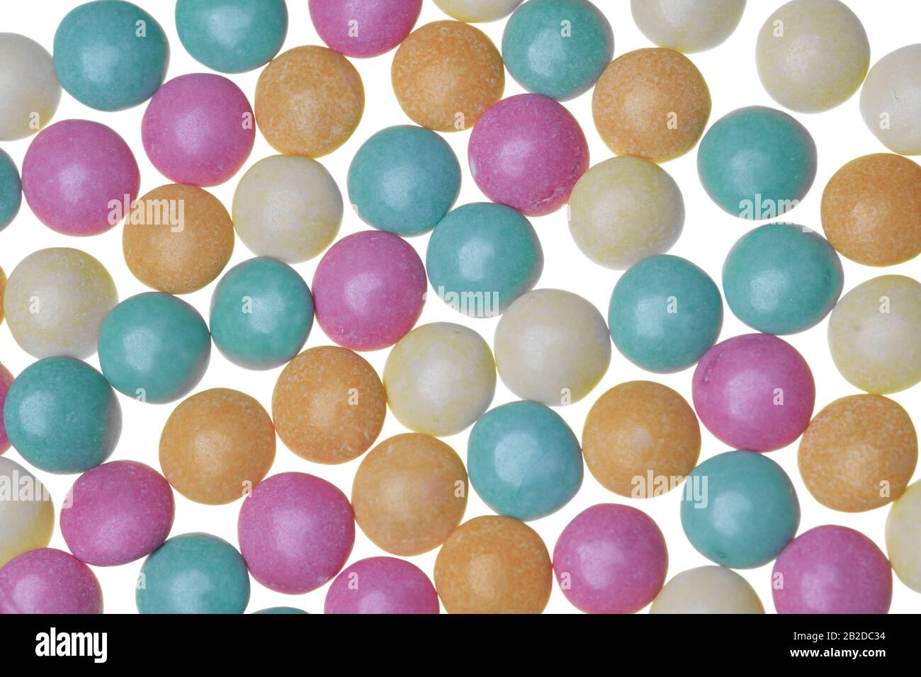 Pastel green, orange, pink and yellow sugar-coaged chocolate candy in ...