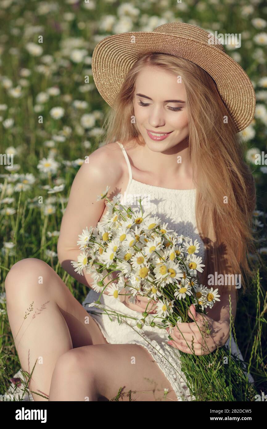 Beautiful woman enjoying field, pretty girl with blonde hair relaxing ...