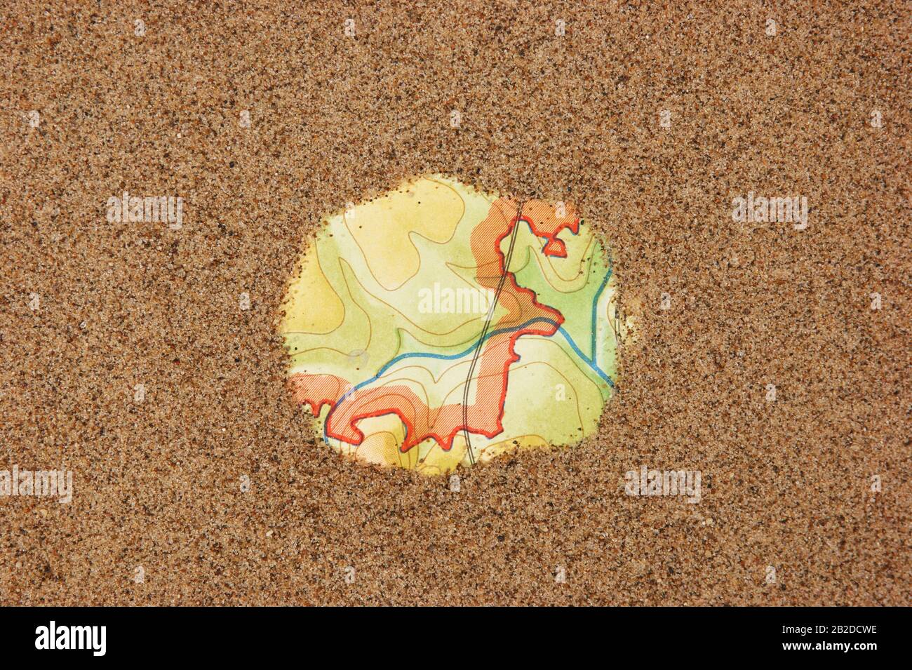 Vintage old map in the sand Stock Photo - Alamy