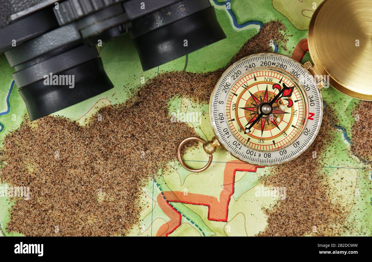 Binoculars compass on map compass hi-res stock photography and images ...