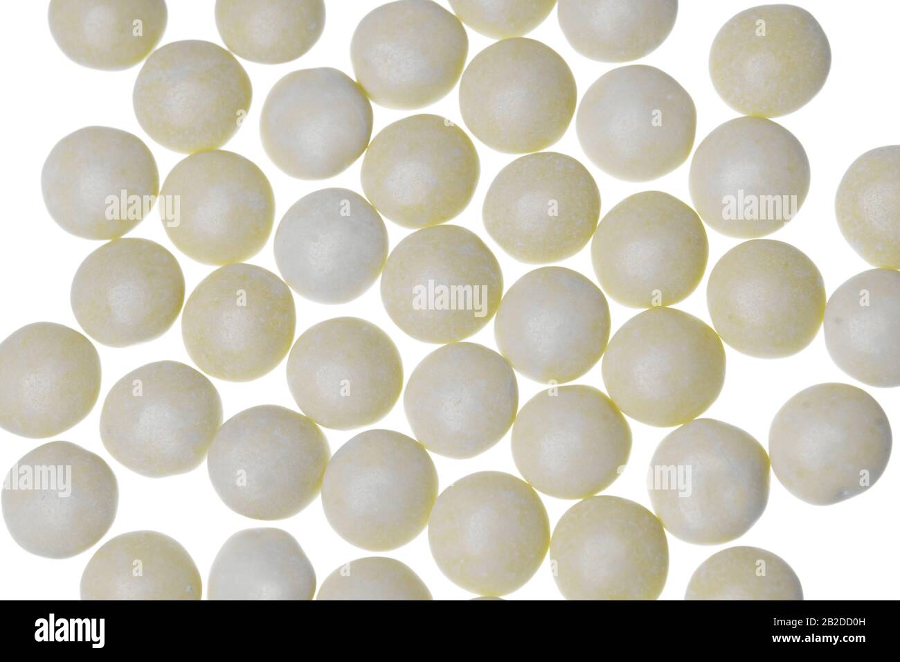 Pastel yellow sugar-coaged chocolate candy in the shape of oblate ...